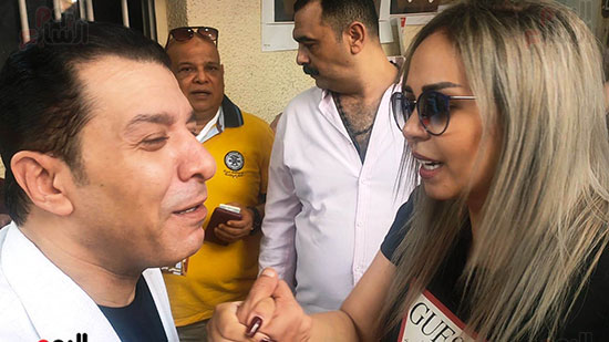 Soma shakes hands with Mustafa Kamel, her husband’s competitor in the ...